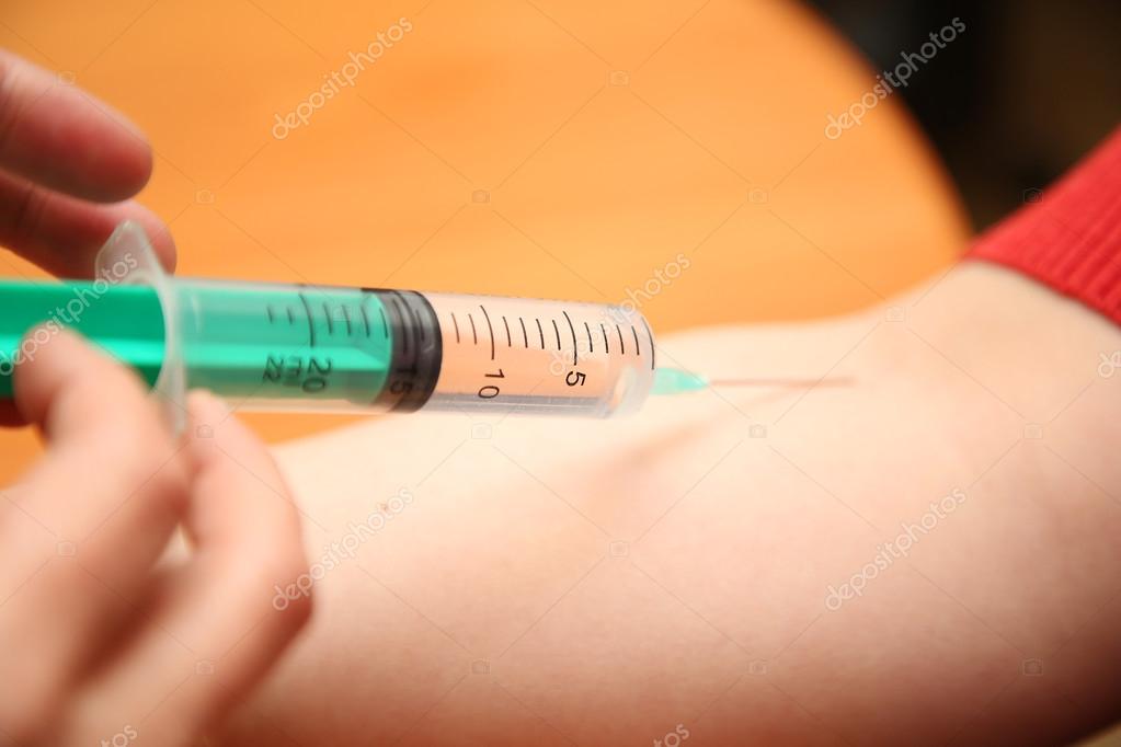 An injection syringe in hand Stock Photo by ©sociopat_mpat 100479658