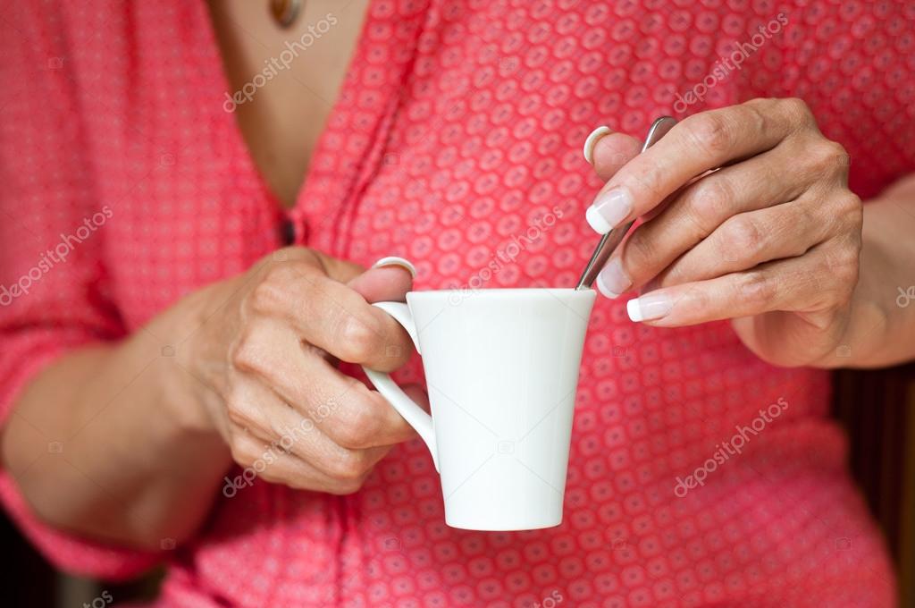 Woman hand with cup of coffee — Stock Photo © NeydtStock #113512066