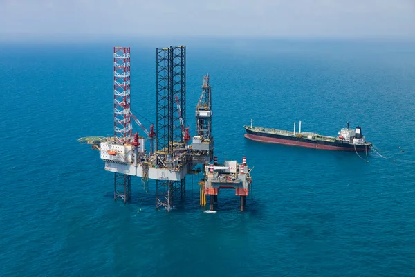 The offshore drilling oil rig and supply boat side view Stock Photo by ...