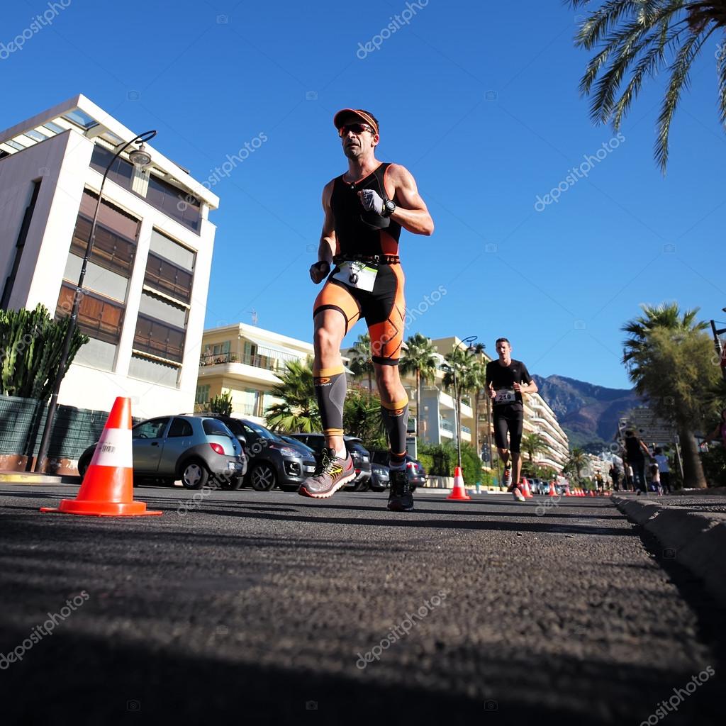 Runner ahead in black suit – Stock Editorial Photo © Tverdohlib.com ...