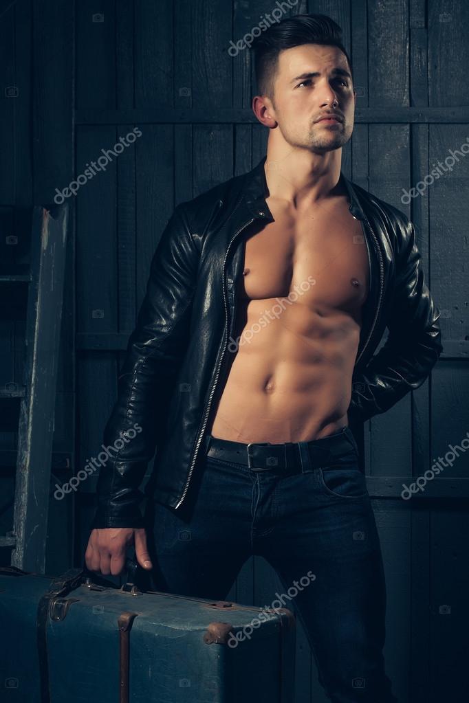 Strong man with suit case Stock Photo by ©Tverdohlib.com 105141884