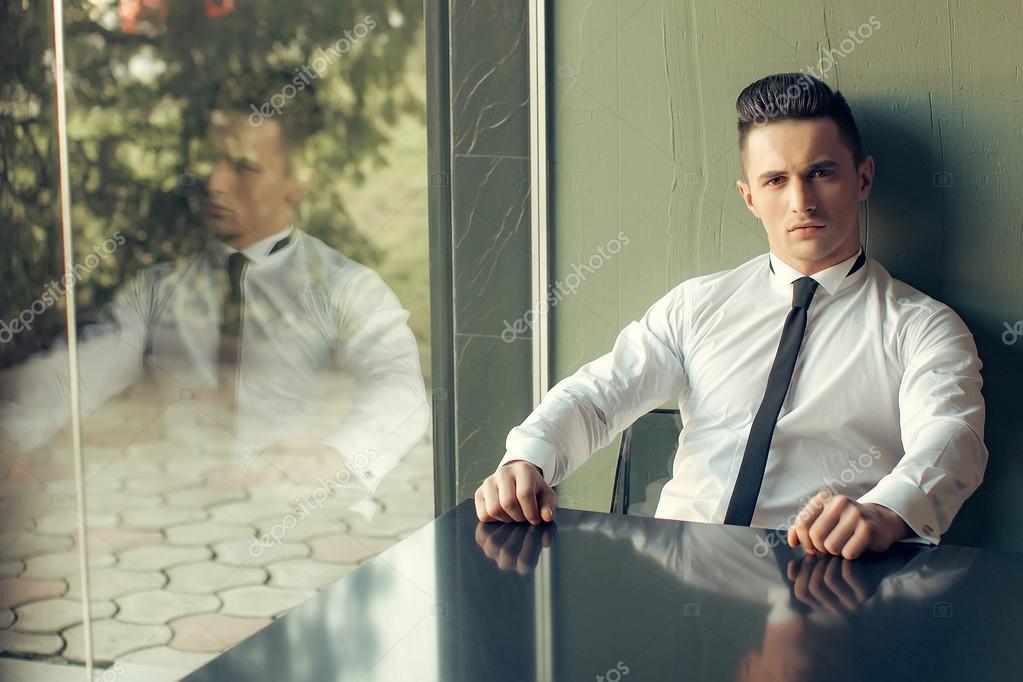 Man model sits at table Stock Photo by ©Tverdohlib.com 105144258