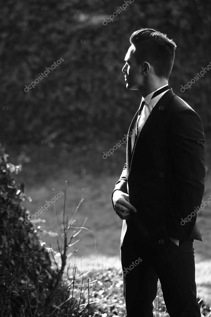 Young man poses on landscape Stock Photo by ©Tverdohlib.com 105369858