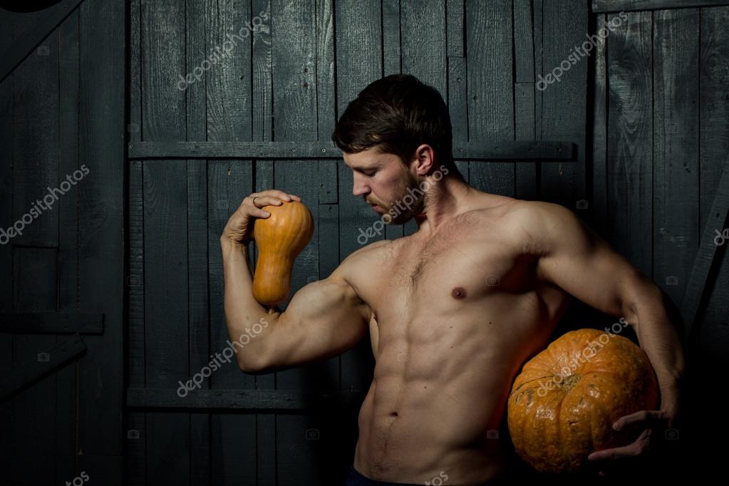 Muscular boy with pumpkin — Stock Photo © Tverdohlib.com #106543468