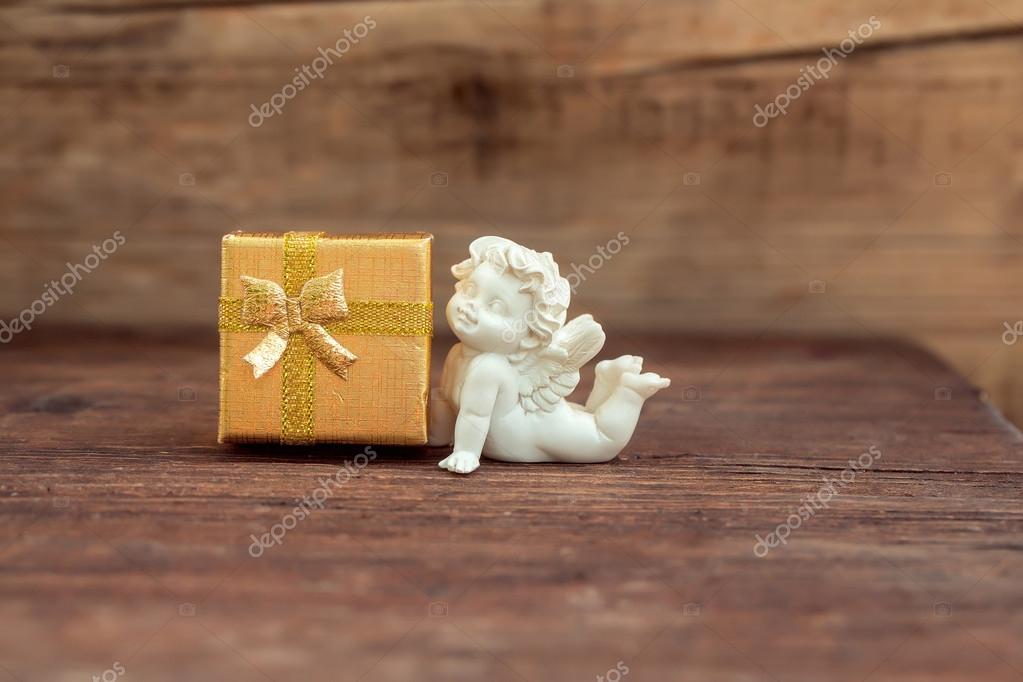Dreaming angel and gift box Stock Photo by ©Tverdohlib.com 121398618