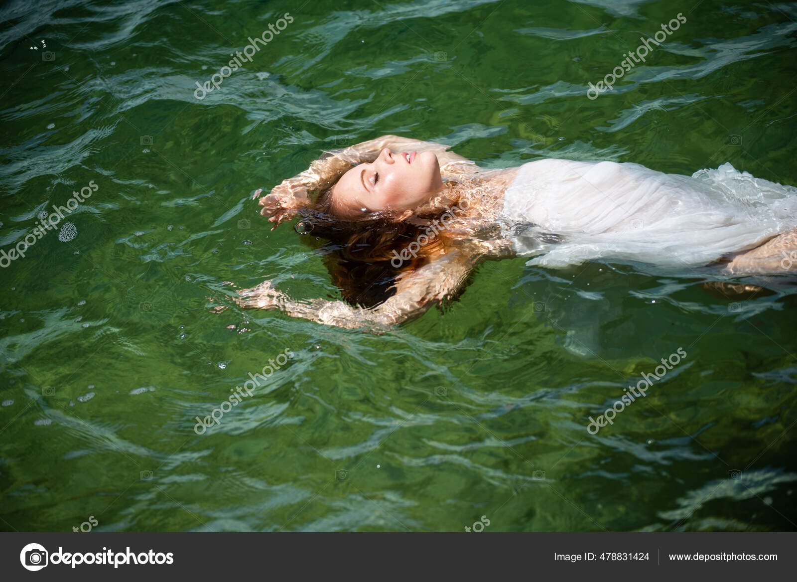 Young woman floating in ocean or sea water, relaxing and taking care of ...