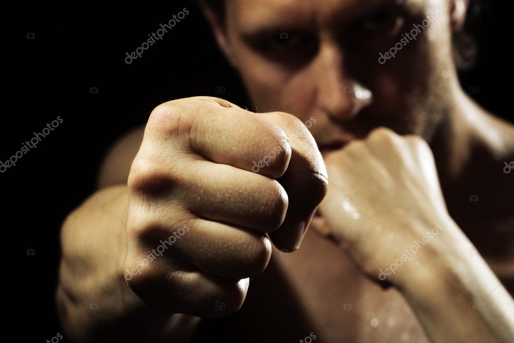 Man in boxing pose Stock Photo by ©Tverdohlib.com 84354946