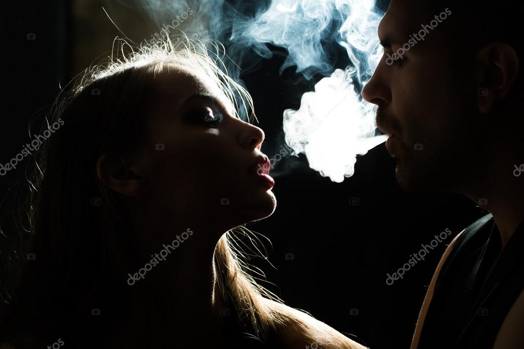Couple puff smoke into face — Stock Photo © Tverdohlib.com #87953772