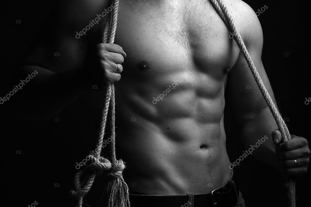 Muscular man with rope Stock Photo by ©Tverdohlib.com 90184946