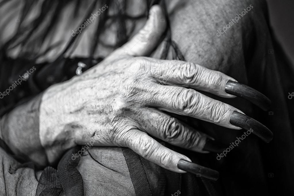 Wrinkled hand with long fingernails Stock Photo by ©Tverdohlib.com 92081136