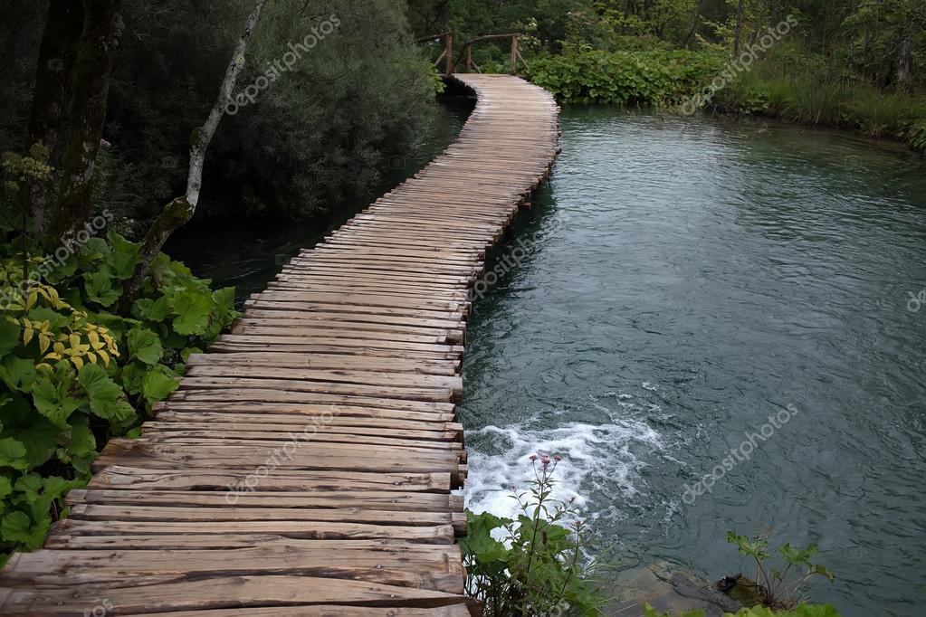 Wooden walkway across river Stock Photo by ©Tverdohlib.com 94553678