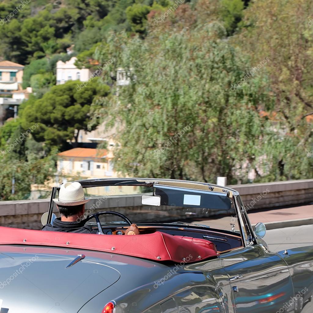 Man driving elegant retro convertible — Stock Photo © Tverdohlib.com ...