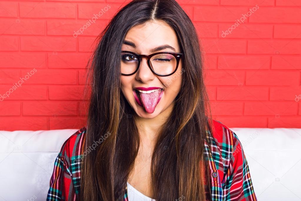 Young woman showing a long tongue Stock Photo by ©AnnHaritonenko 75375263