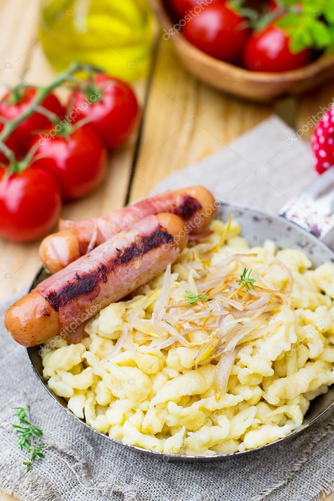 German noodles Spatzle with fried onions and sausages Stock Photo by ...