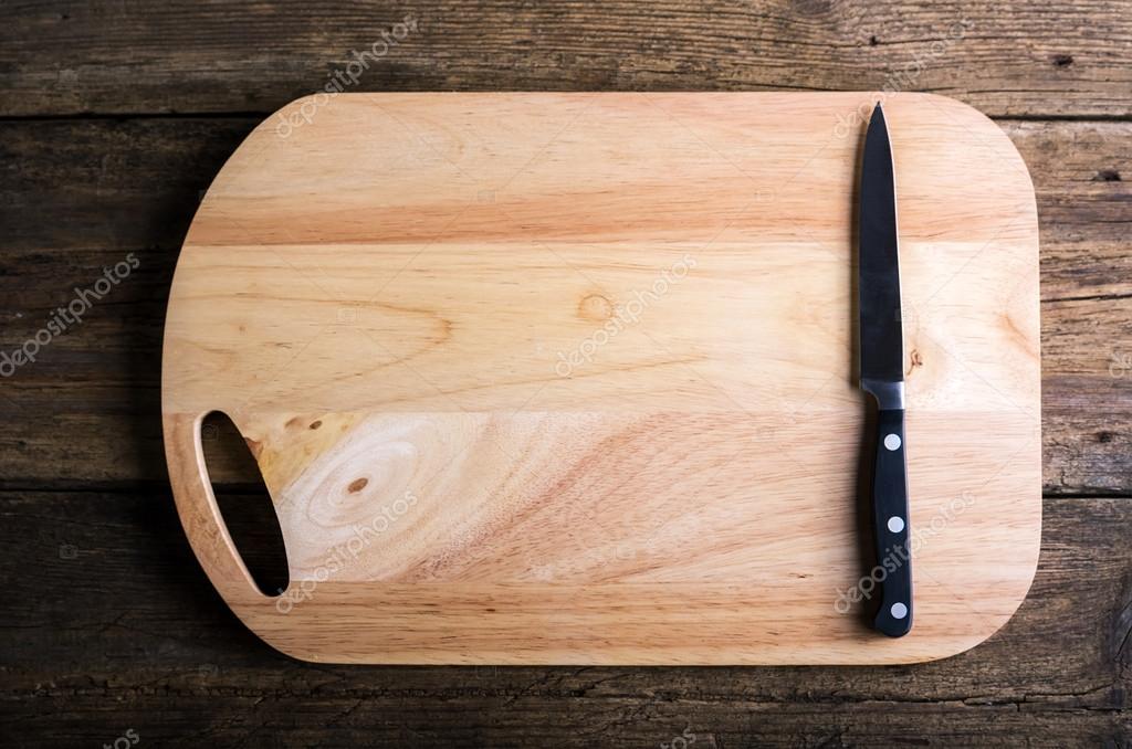 Empty chopping board with a sharp paring knife on a distressed grunge ...