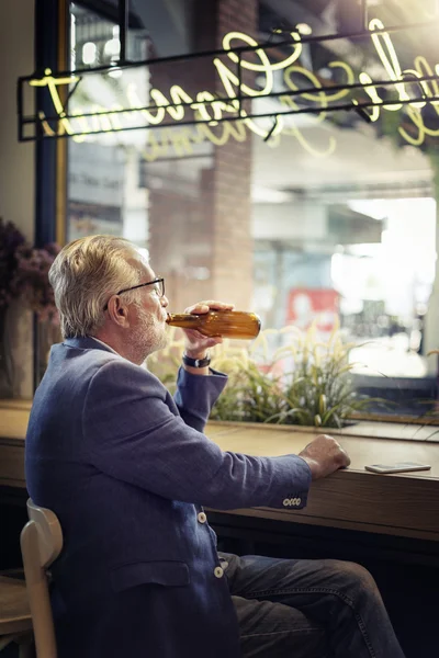 Senior Man drinking in bar - Stock Image - Everypixel