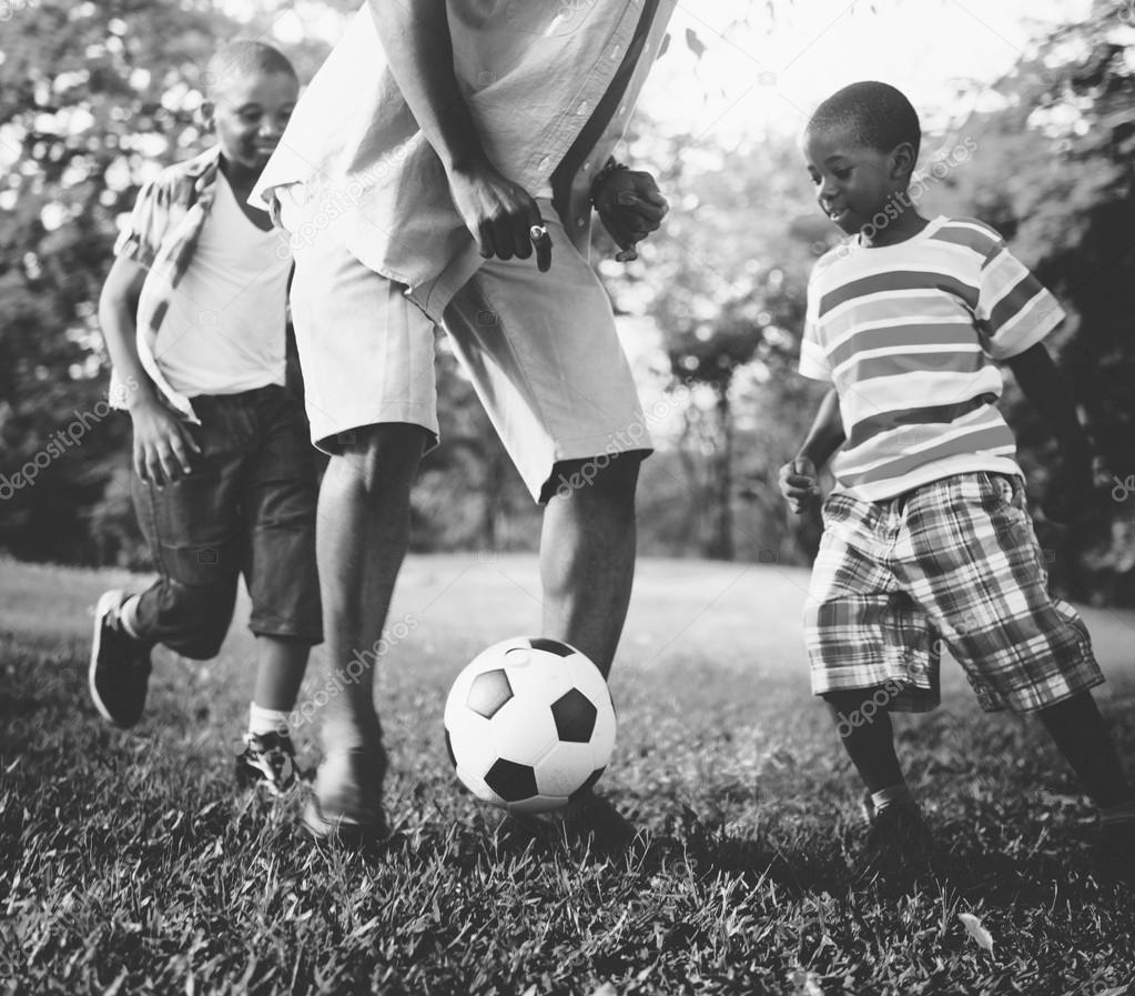 Father playing football with children — Stock Photo © Rawpixel #114297804