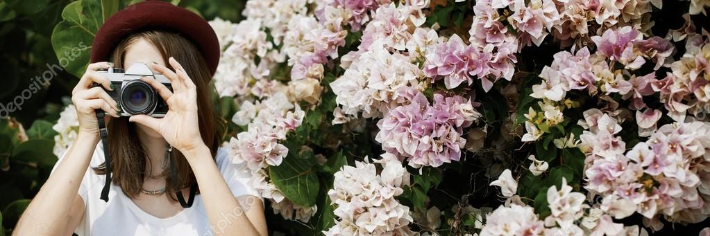 Woman with camera surrounded by flowers — Stock Photo © Rawpixel #114482246