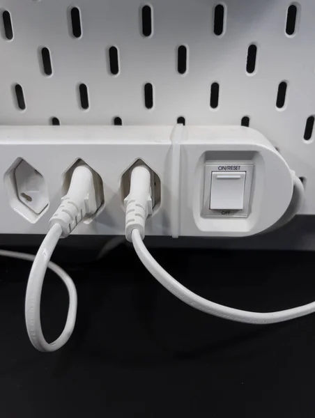 Electrical splitter with sockets and switch. Two cables are connected ...