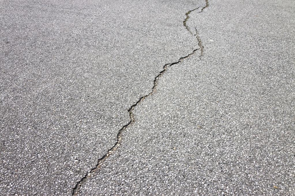 Asphalt road damaged after a structural failure Stock Photo by ...