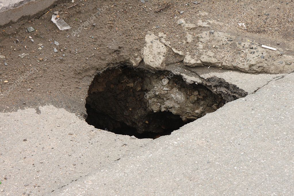 A big deep black hole on the pavement Stock Photo by ©suslovsv 53541243