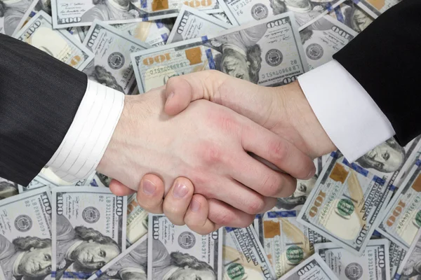 Handshake with the transfer of money Stock Photo by ©GrashAlex 62000625