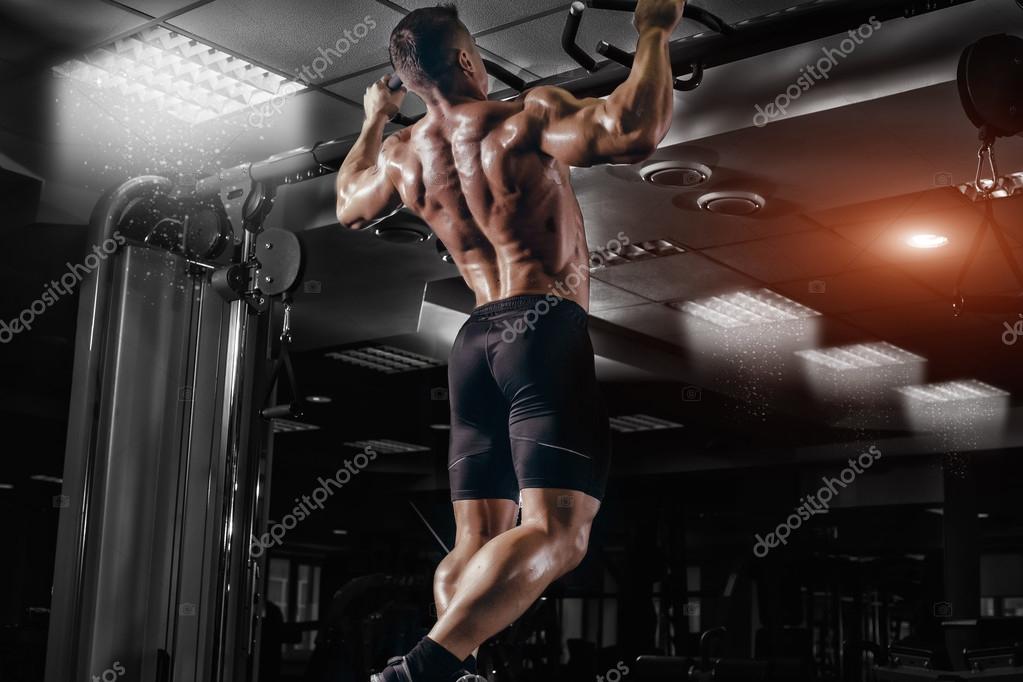 Muscle athlete man in gym making elevations. Bodybuilder trainin Stock ...