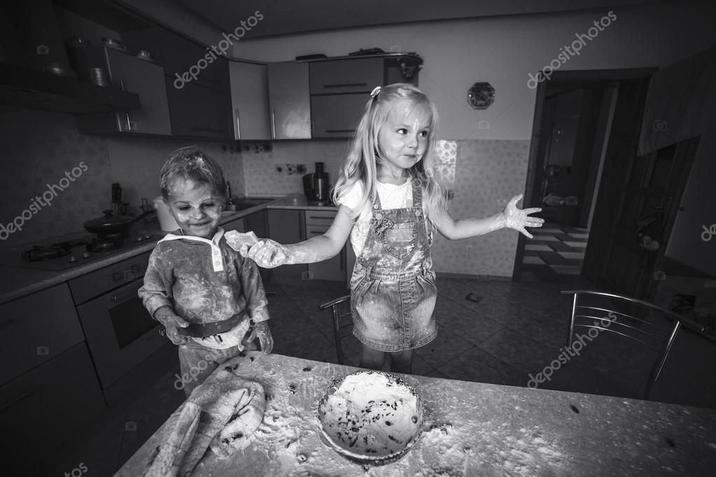 Children playing in the kitchen Stock Photo by ©simbiothy 65494815