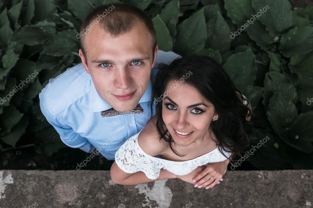 Young European couple cuddling on a park bench Stock Photo by ...