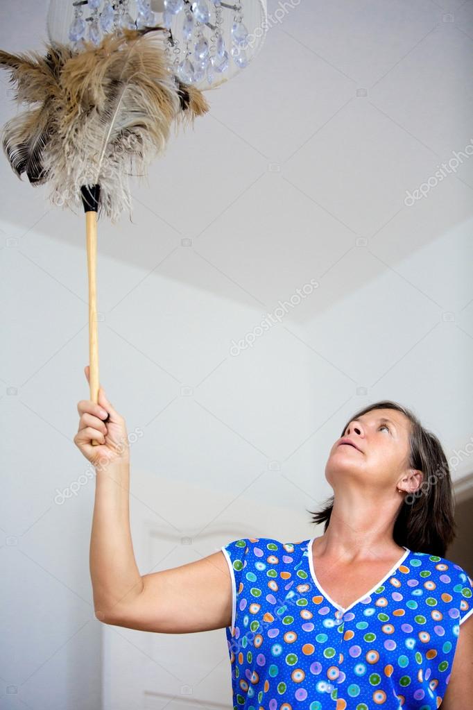 Woman cleaning with feather dusters Stock Photo by ©wernerimages 53944883