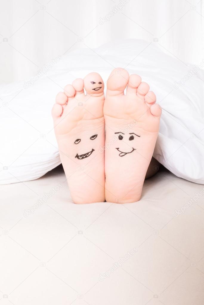 Bare feet with smiley faces — Stock Photo © wernerimages #54494951