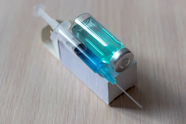 A bottle and a syringe for injection. The concept of vaccination for ...