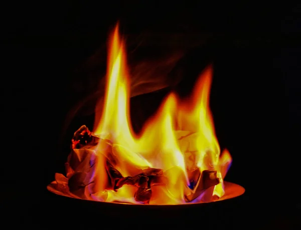 Fire. Burning paper on fire. Flames in the dark. Ash. The concept of ...