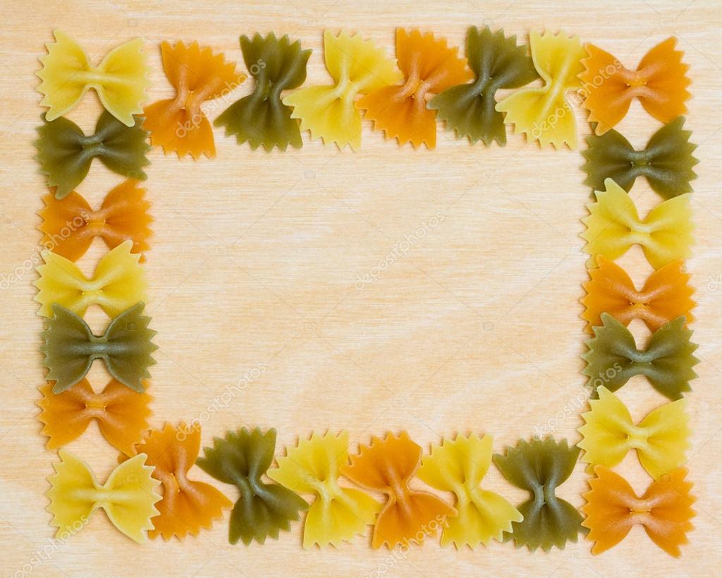 Tri Color Bow Tie Pasta Border on Wooden Background — Stock Photo ...