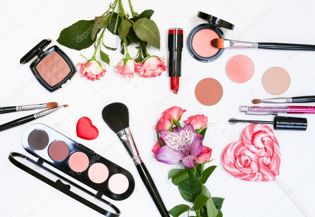 Composition with makeup cosmetics, brushes, shadoes and flowers on ...