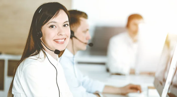 Asian woman working at customer service office. Business concept. Group of diverse operators at ...