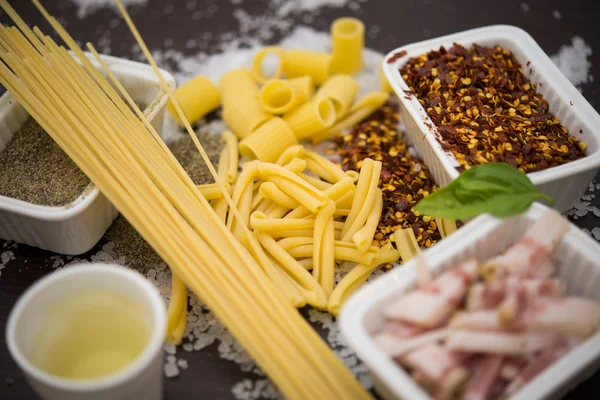 Pasta and ingredients typical of Italian cuisine - Stock Image - Everypixel