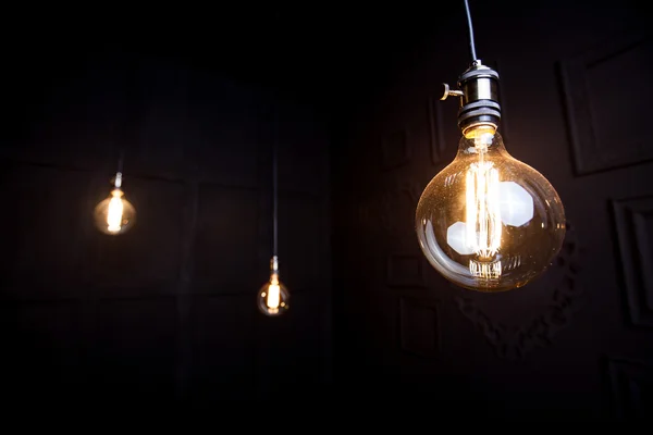 Light bulb on black background — Stock Photo © 4masik #107040770