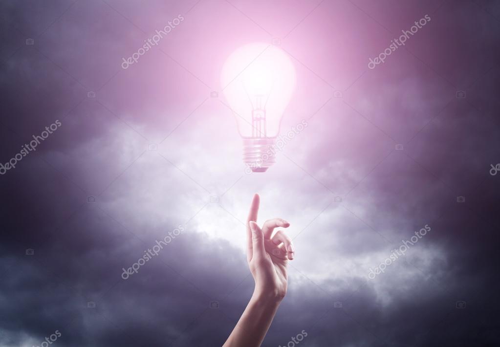 Woman hand reaching for light bulb — Stock Photo © 4masik #61060445