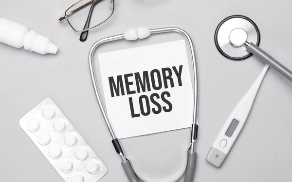 In the notebook is the text memory loss, stethoscope, pills, and ...
