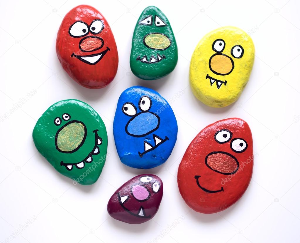 Seven smiling faces of monsters. Painted acrylic pebbles. — Stock Photo ...