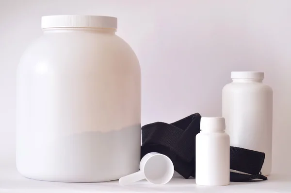 Big jar of protein powder, bottles and shaker - Stock Image - Everypixel