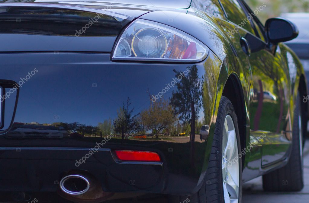 Rear-side view of a luxury car with natural reflection nature — Stock ...