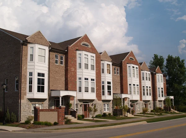 Red brick condos or town homes with the garage in the front. Stock ...