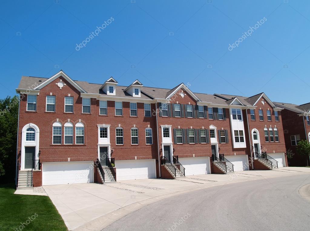 Red brick condos or town homes with the garage in the front. Stock ...