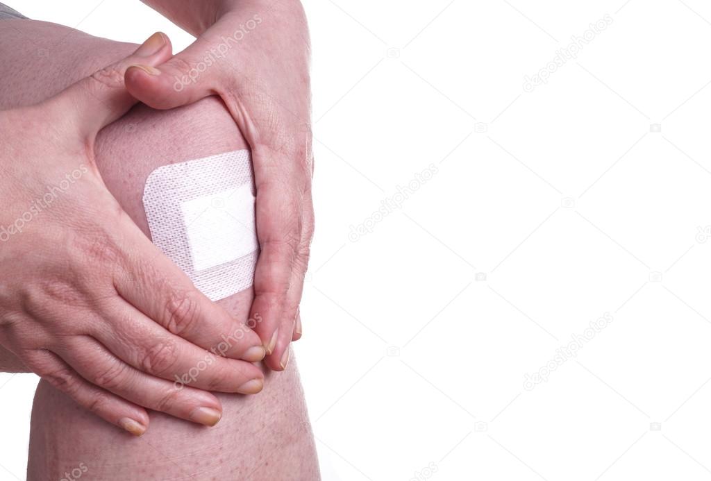 Plaster on a Womans Knee — Stock Photo © Esbenklinker #70172739
