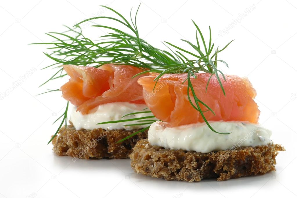 Two salmon canapes with fresh dill garnish, isolated on white b Stock ...