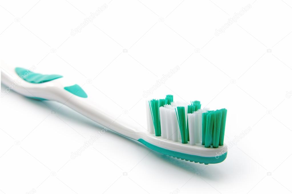 Green toothbrush on a white background, close up Stock Photo by ...