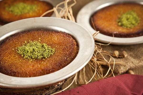 Delicious traditional Turkish kunefe with pistachio on it. Served hot ...
