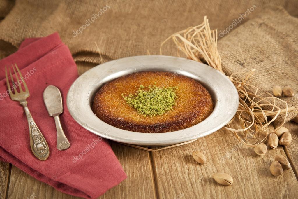 Delicious traditional Turkish kunefe with pistachio on it. Served hot ...
